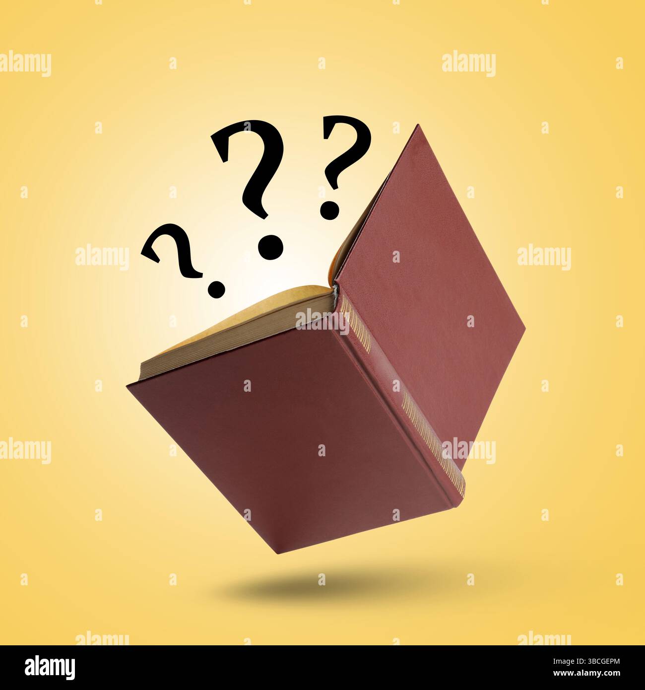 Question marks above open book in air against golden background Stock ...