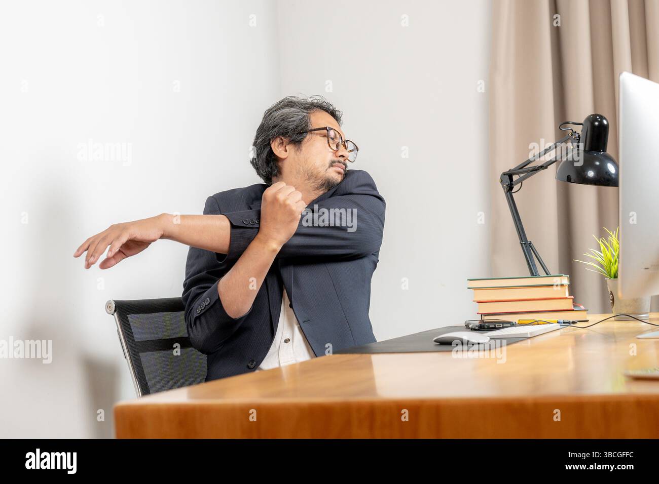 Work-life balance in action, a businessman takes a moment to stretch ...