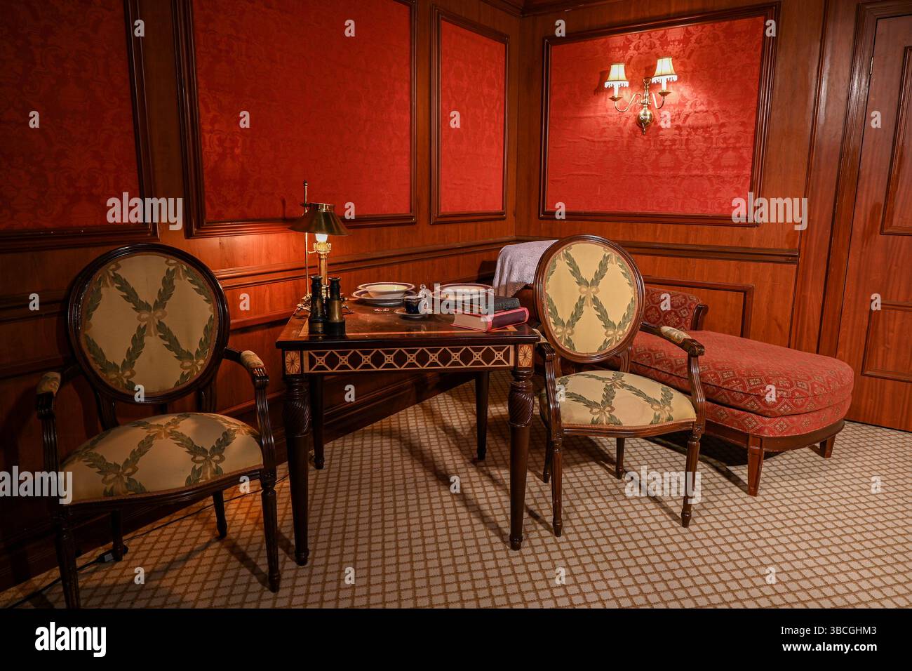 Luxurious vintage dining setting featuring a table, chairs, chaise lounge, and warm lighting in ...