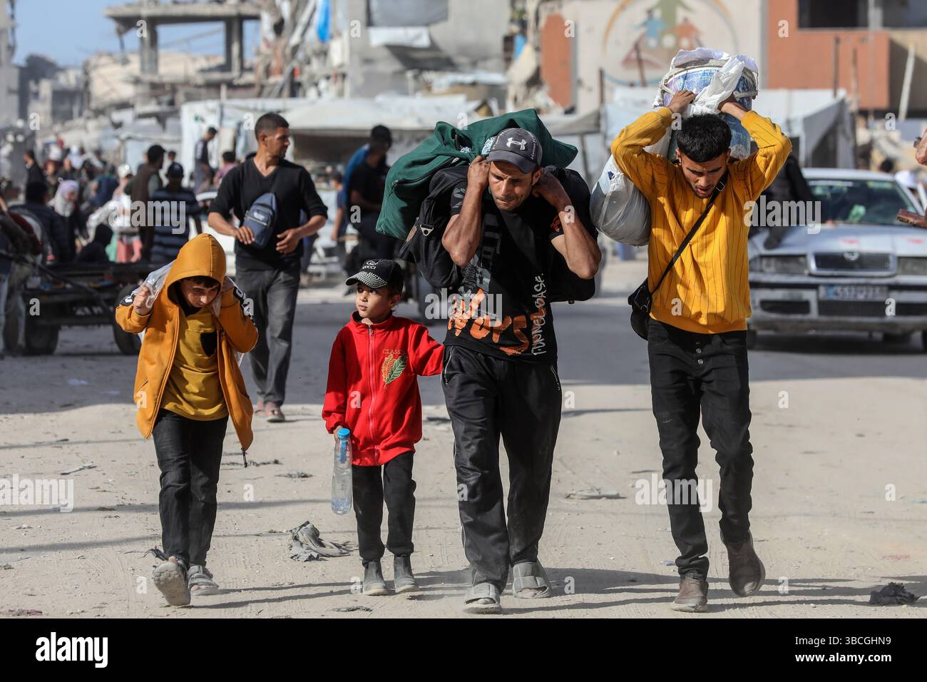 Jabalia, Gaza Strip. 19th May, 2025. Palestinians, carrying their ...