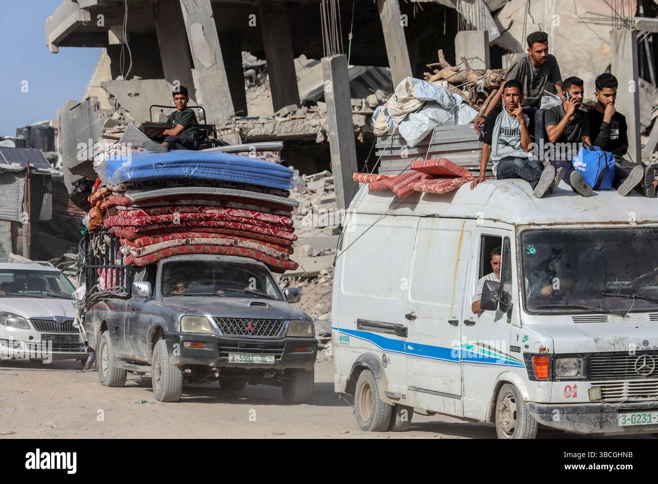 Jabalia, Gaza Strip. 19th May, 2025. Palestinians, carrying their ...