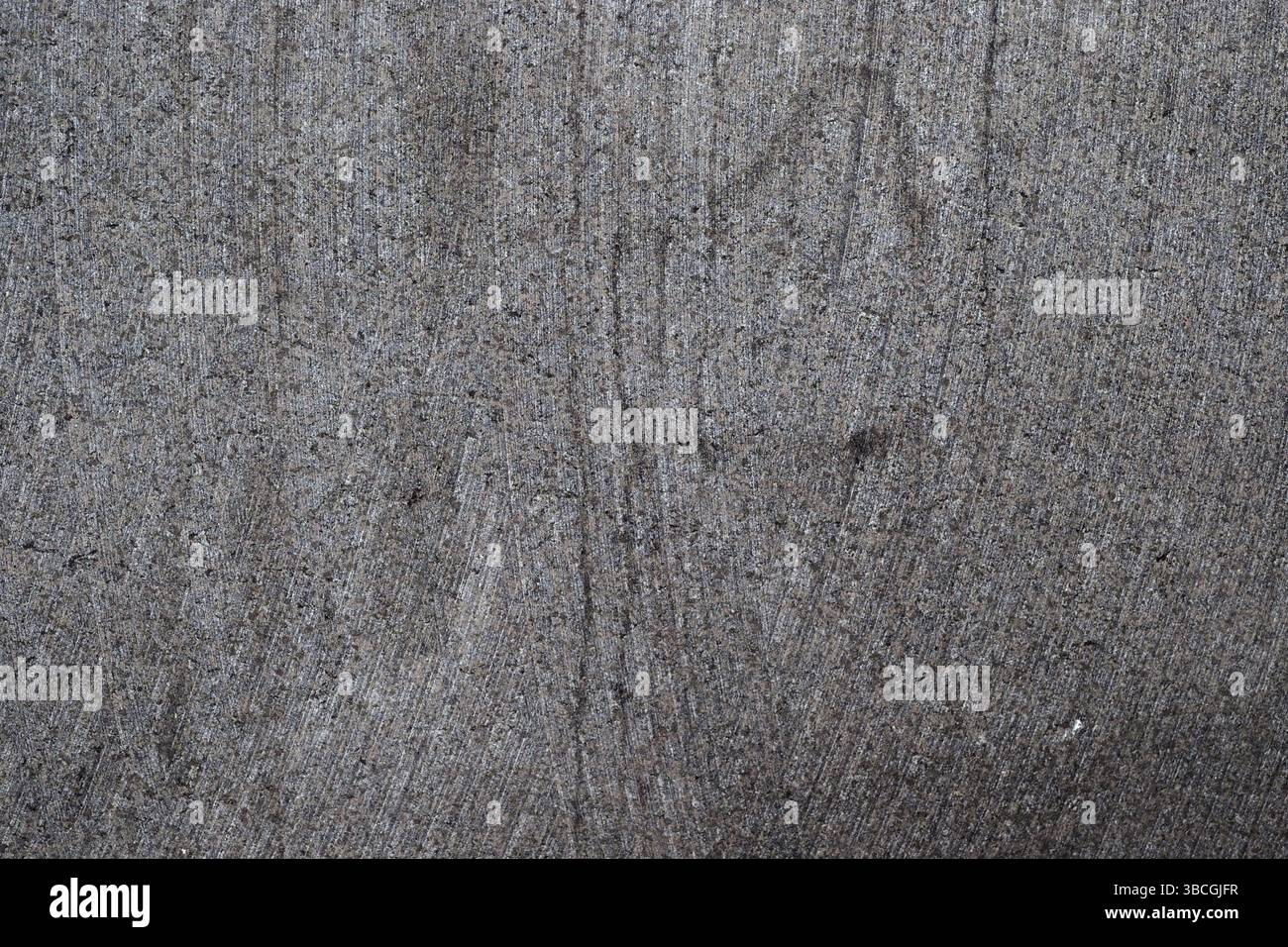 A close-up view of a gray concrete surface showcasing subtle texture ...