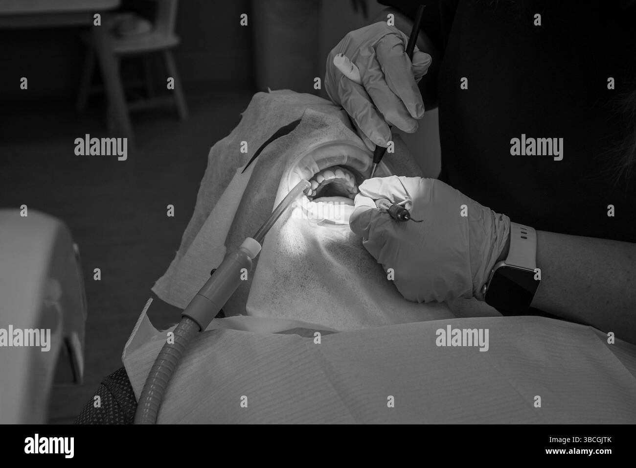 Dentist performing dental checkup on patient's teeth using instruments ...