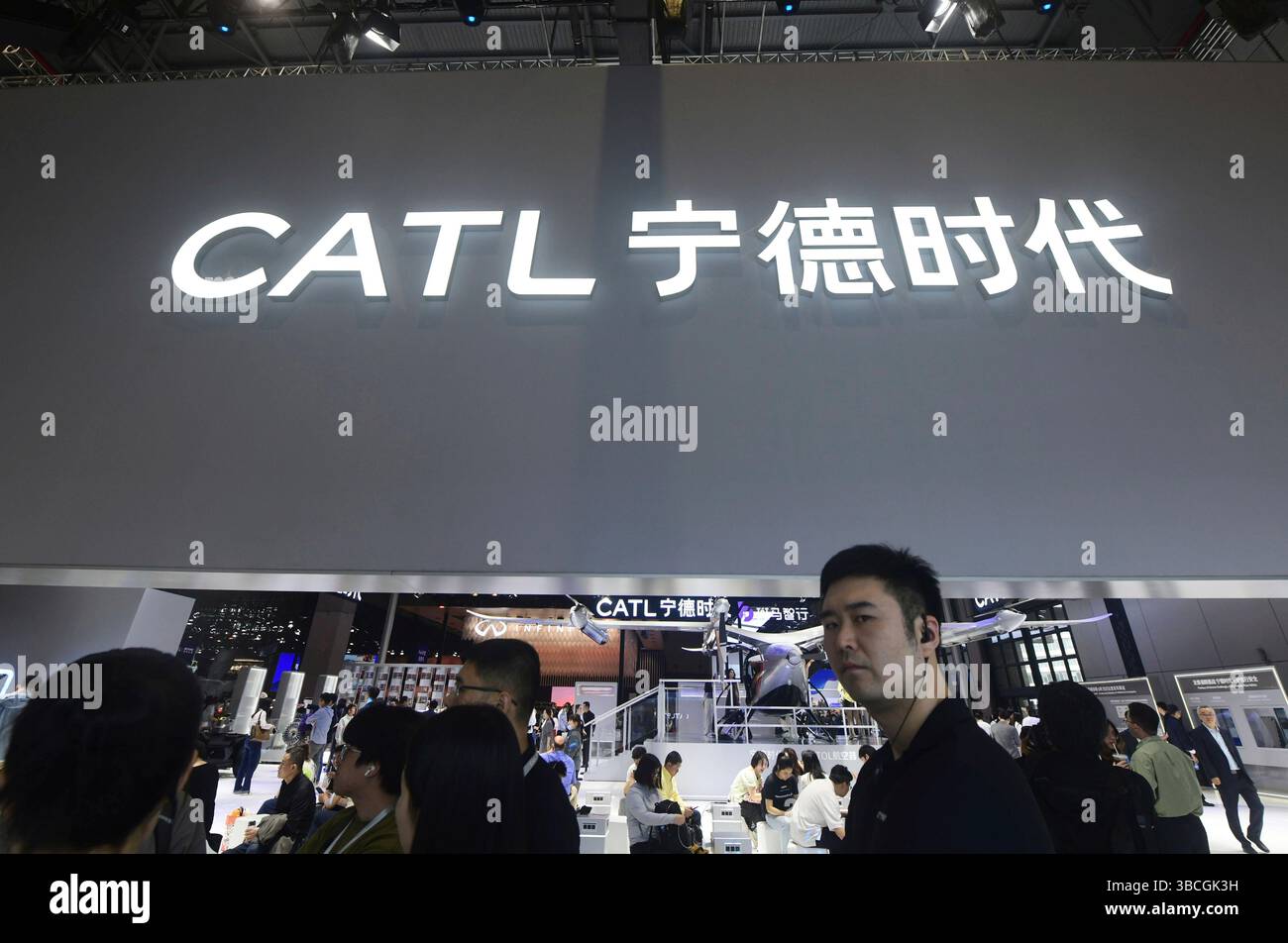 People visit the booth of CATL, a major power battery maker, during Shanghai Auto Show in ...