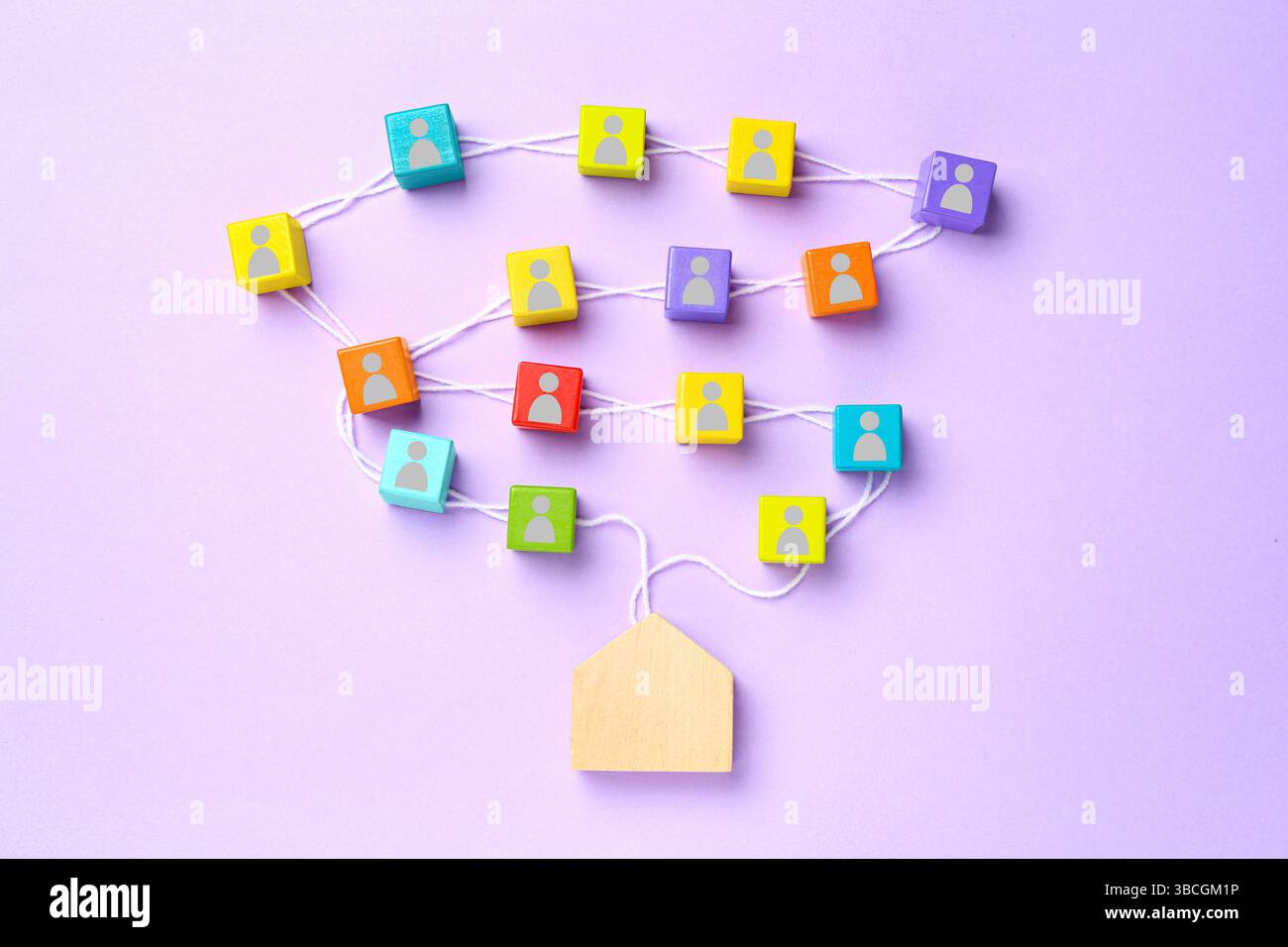 Colorful cubes with human icons on white rope leading to wooden house ...