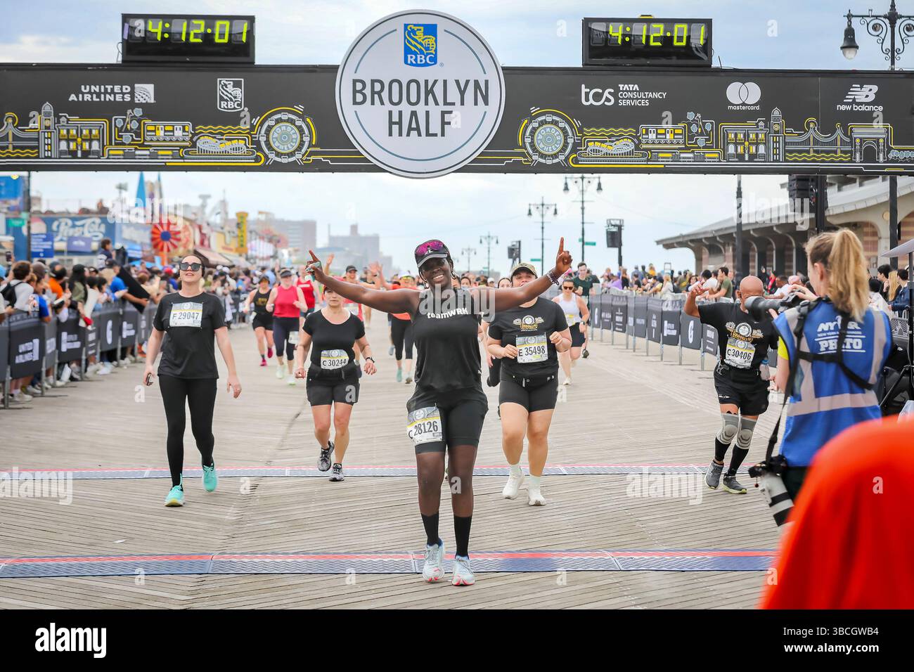 NEW YORK, NEW YORK - MAY NEW YORK, NEW YORK - MAY 17: Runners cross the ...