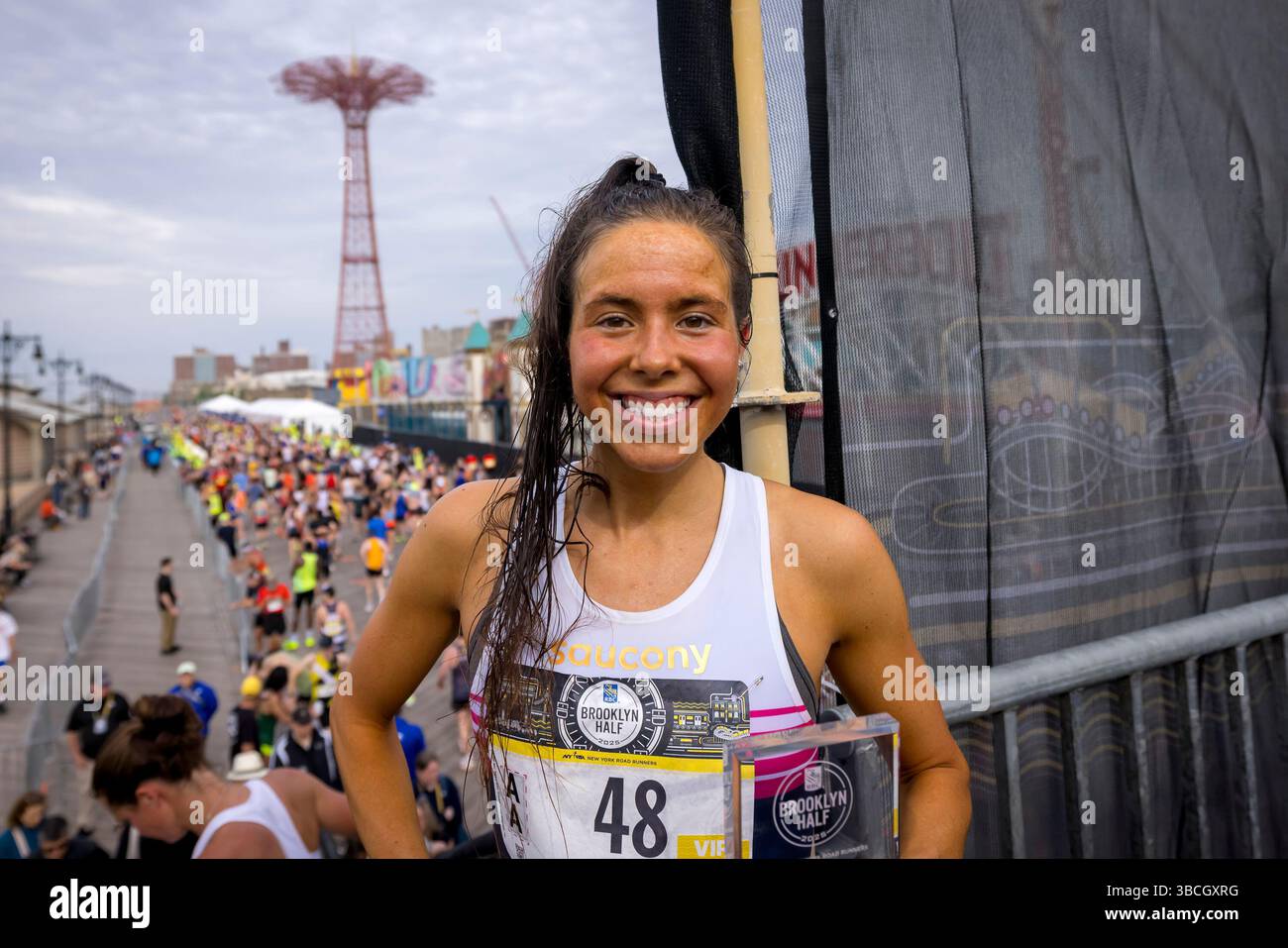 Women's top finisher Felicia Pasadyn holds her trophy at the finish ...