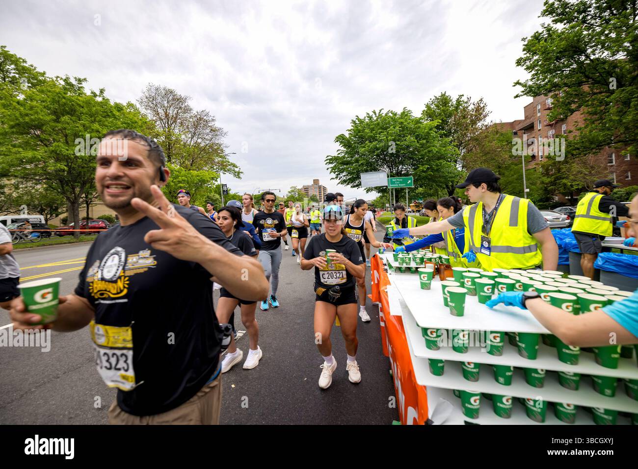 NEW YORK, NEW YORK - MAY NEW YORK, NEW YORK - MAY 17: Runner grab cups ...