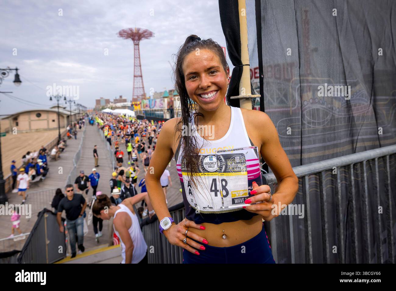 Women's top finisher Felicia Pasadyn holds her trophy at the finish ...
