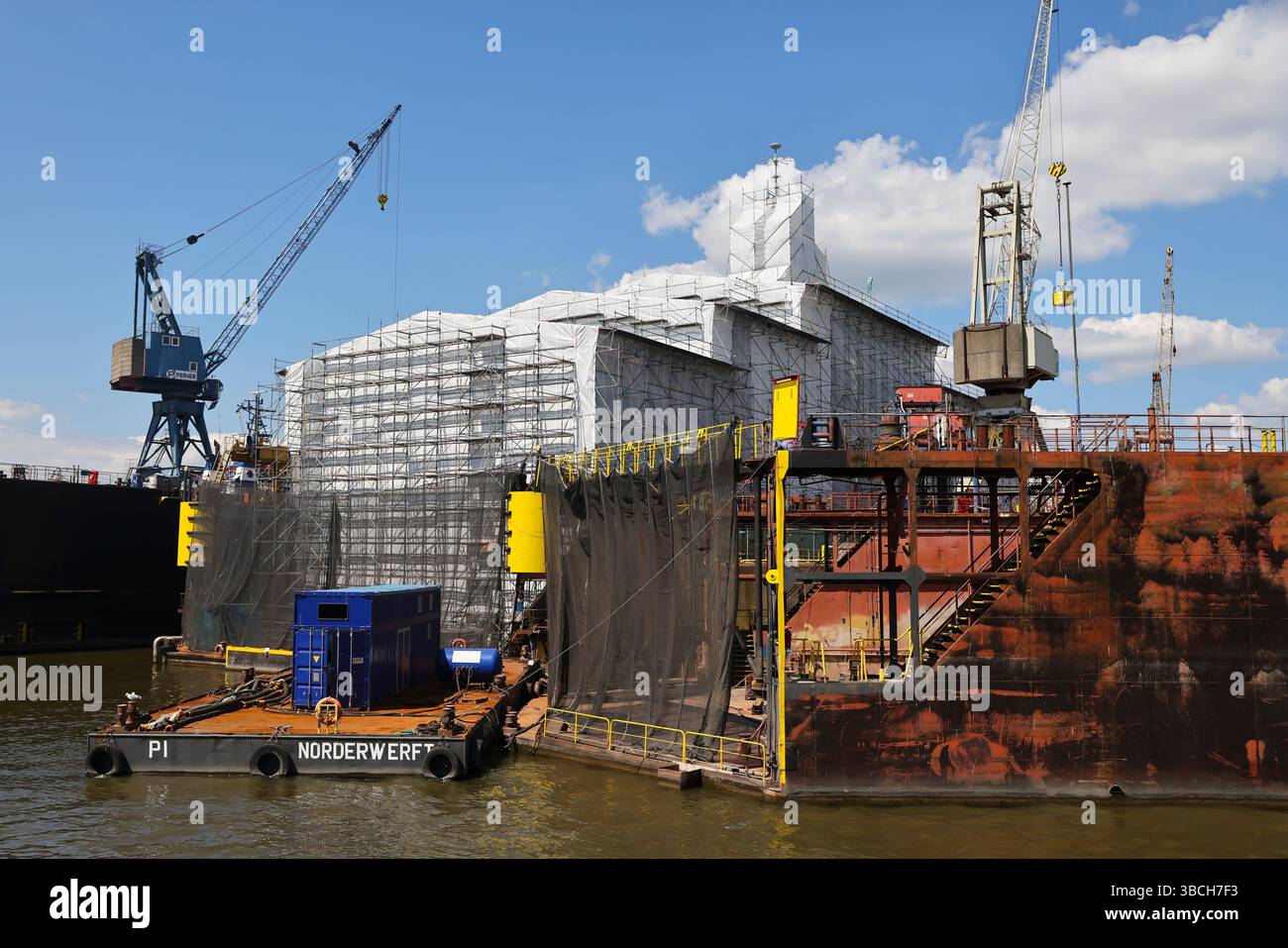 Hamburg, Germany. 20th May, 2025. A ship under a tarpaulin cover lies ...