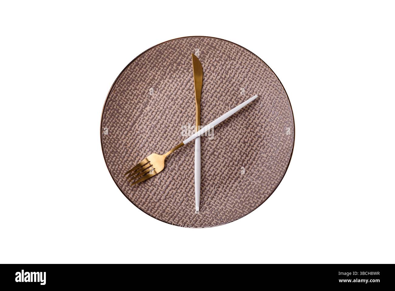 Empty plate with devices in the form of clock hands as a conceptual ...