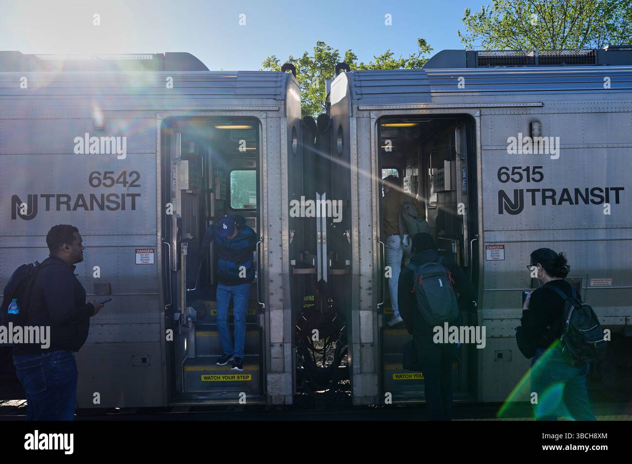 People board a NJ Transit train in Hackensack, N.J., Tuesday, May 20 ...