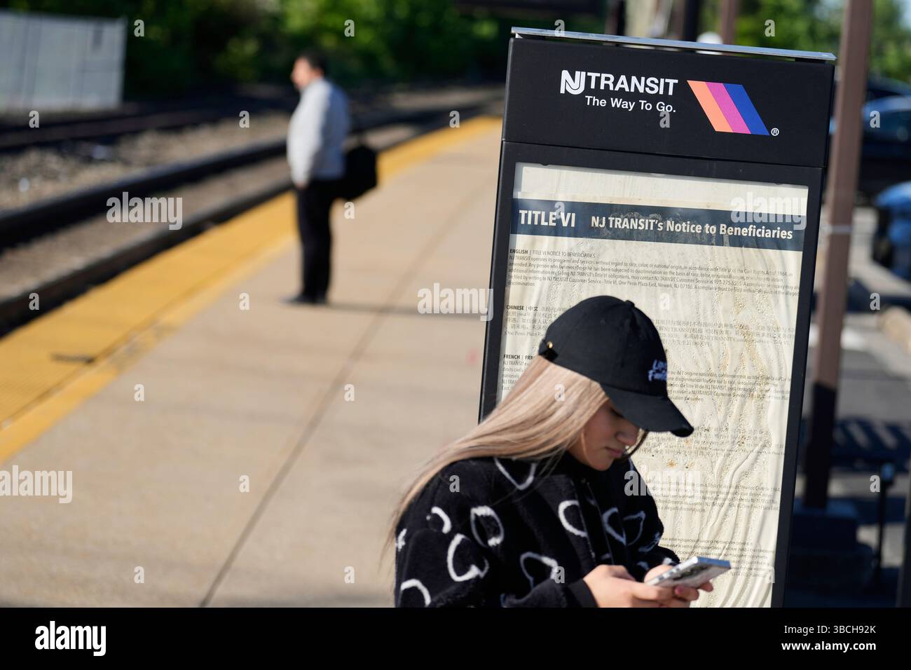 People wait for a NJ Transit train in Hackensack, N.J., Tuesday, May 20 ...