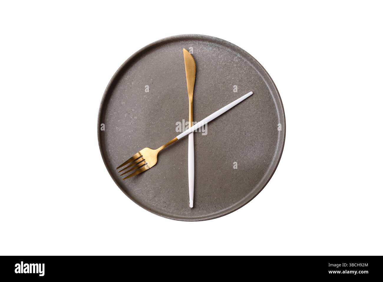 Empty plate with devices in the form of clock hands as a conceptual ...
