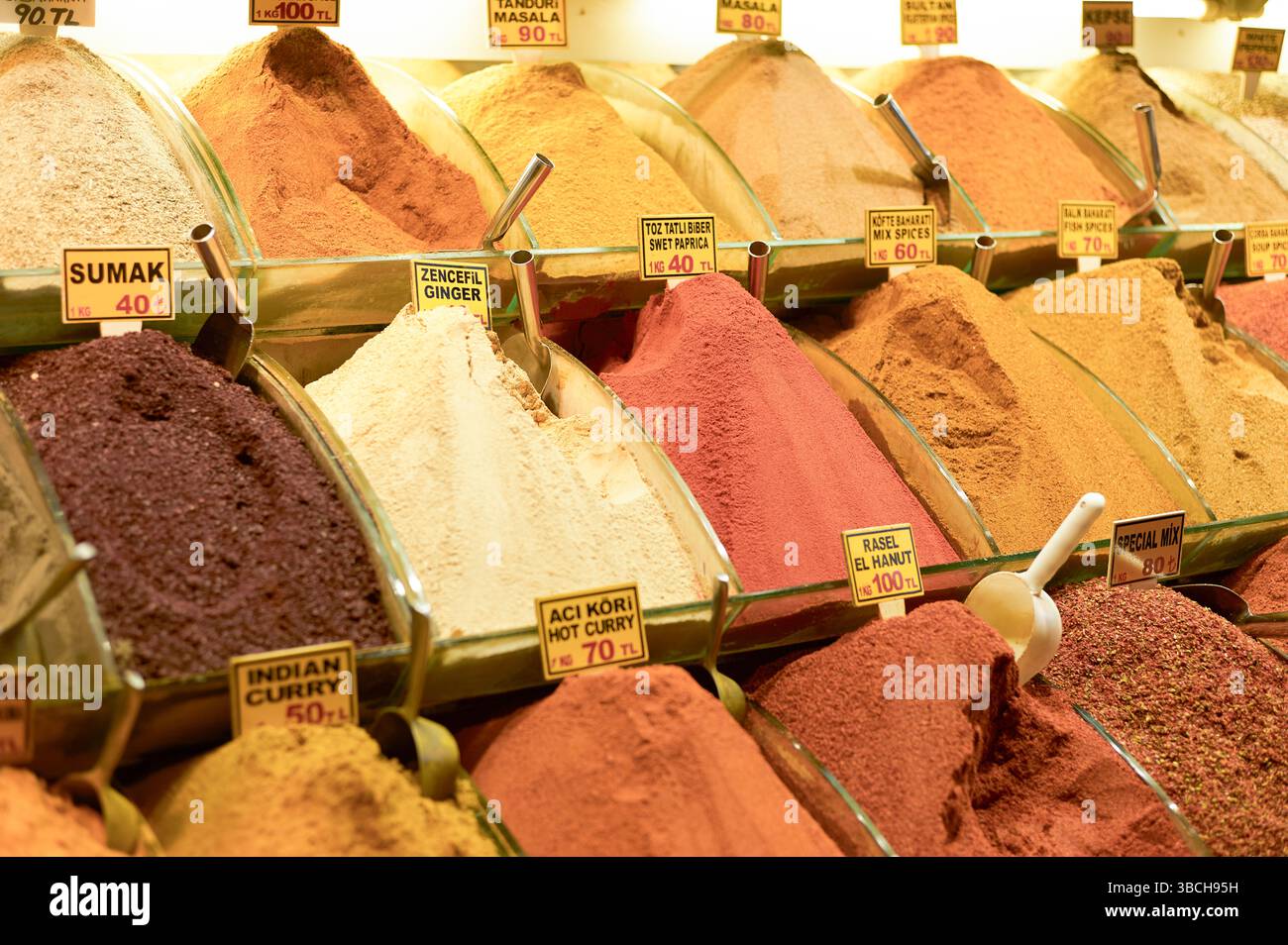 Sacks of colorful spices displayed with labels at a vibrant spice ...