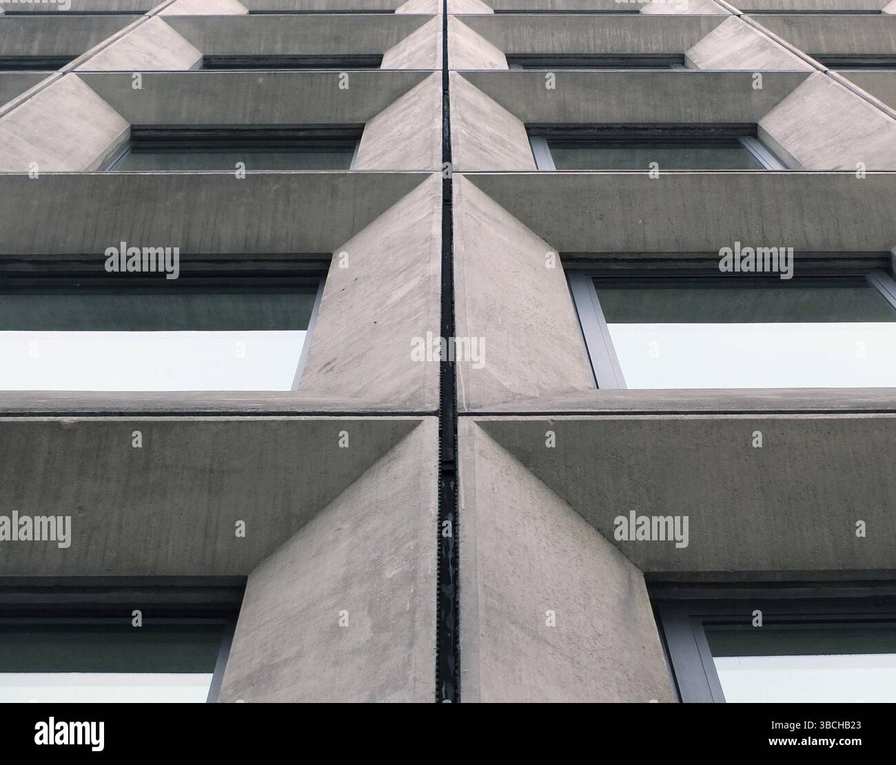 Perspective view of geometric angular concrete windows on the facade of ...