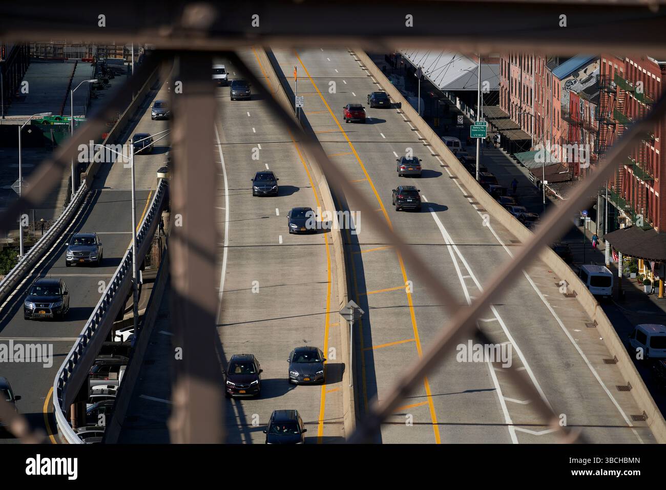 Elevated view of cars on a highway with industrial buildings on the ...