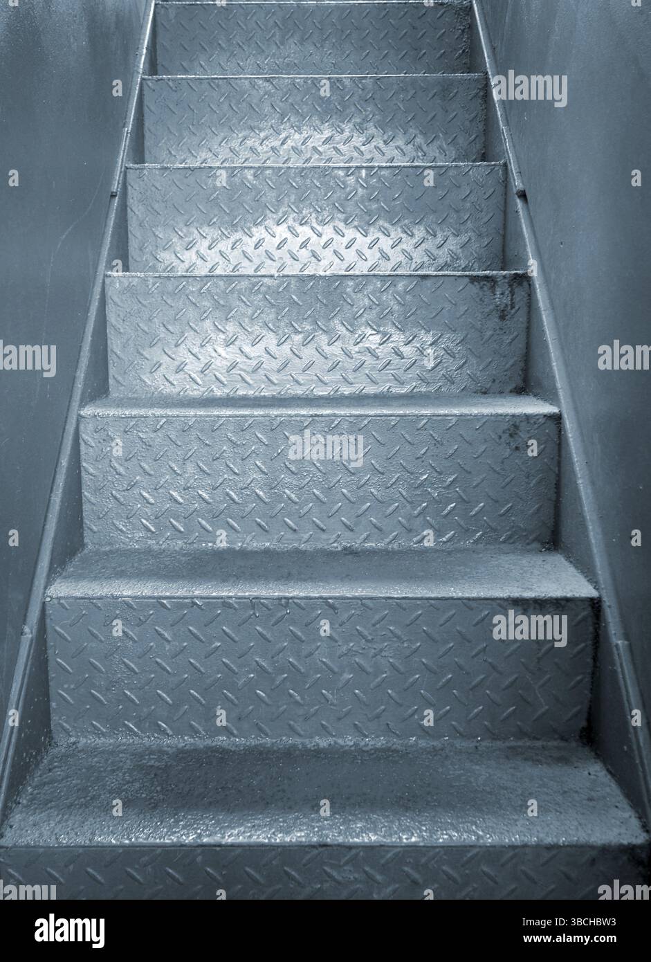 Grey steel industrial staircase with rough patterned grip texture in a ...