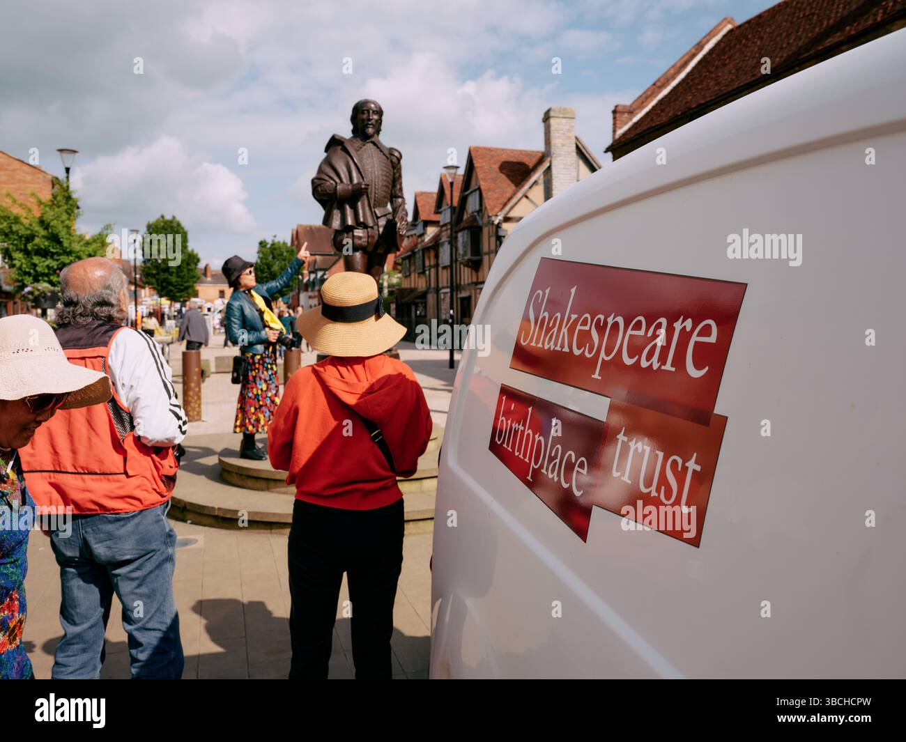 Shakespeare Birthplace Trust sign and tourists admiring the Shakespeare ...
