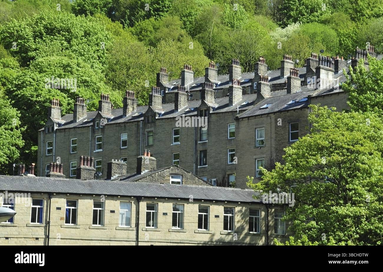 Hillside streets of tall stone houses set in the woodland landscape i ...
