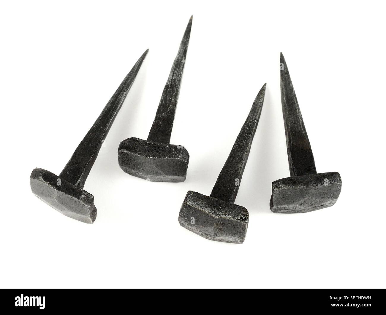 Iron forged nails on a neutral background Stock Photo - Alamy