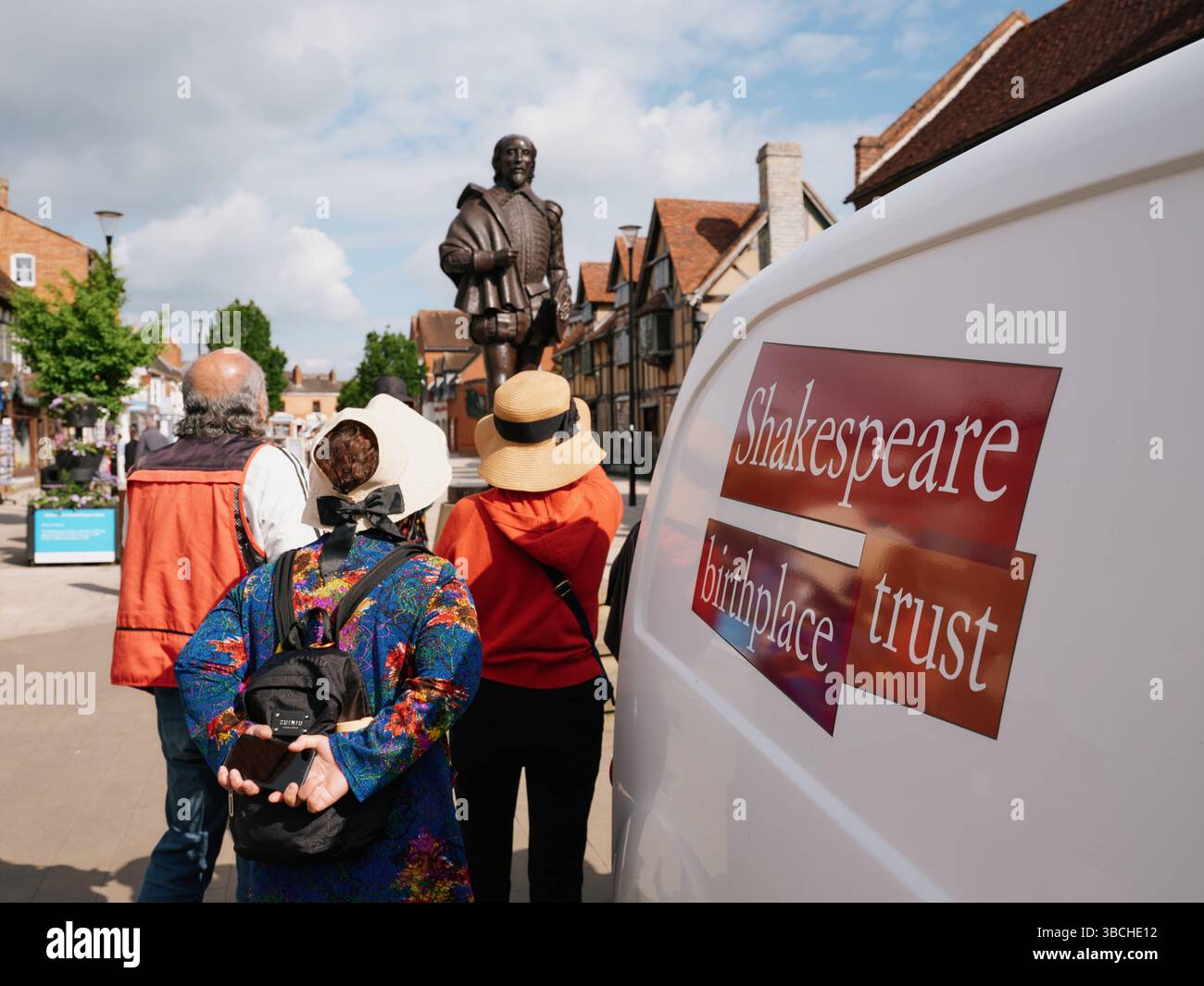 Shakespeare Birthplace Trust sign and tourists admiring the Shakespeare ...