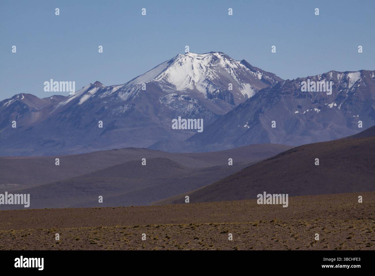 Mountain range without plants covered with snow made of black lava rock ...