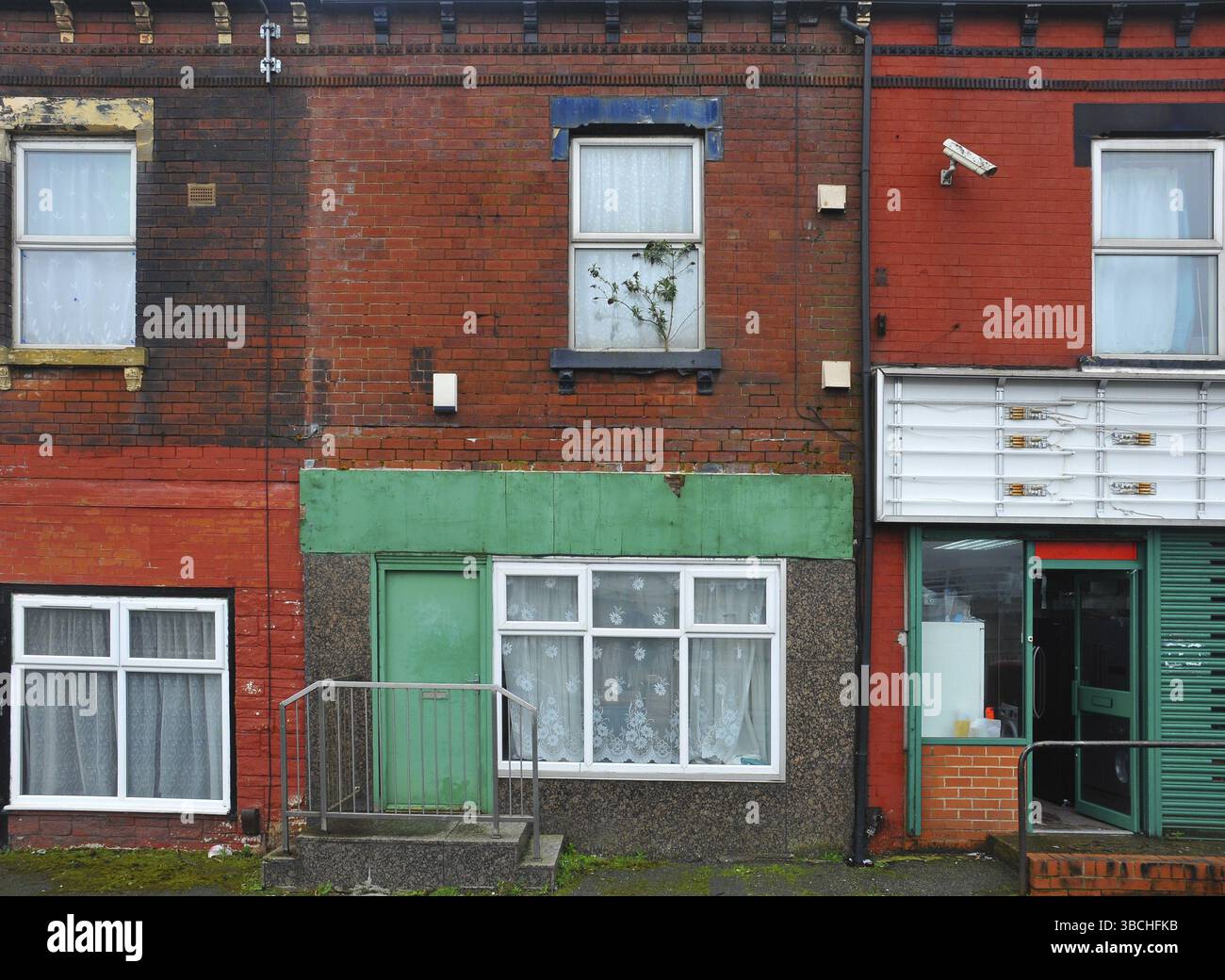 Run down terraced houses on a street in leeds with shabby decaying ...