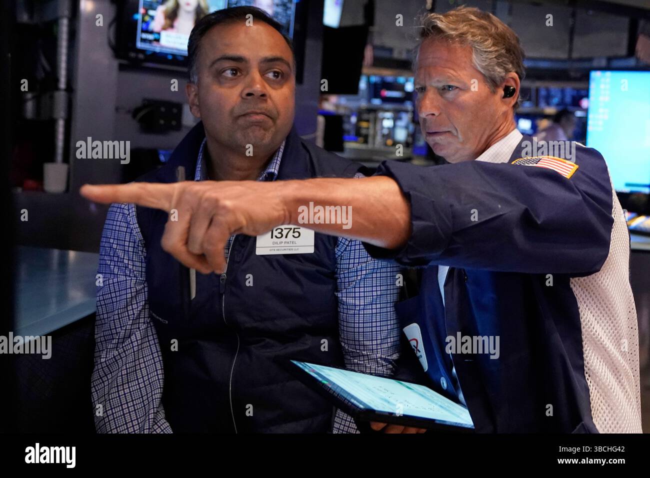 Specialist Dilip Patel, left, and trader Robert Charmak work on the ...