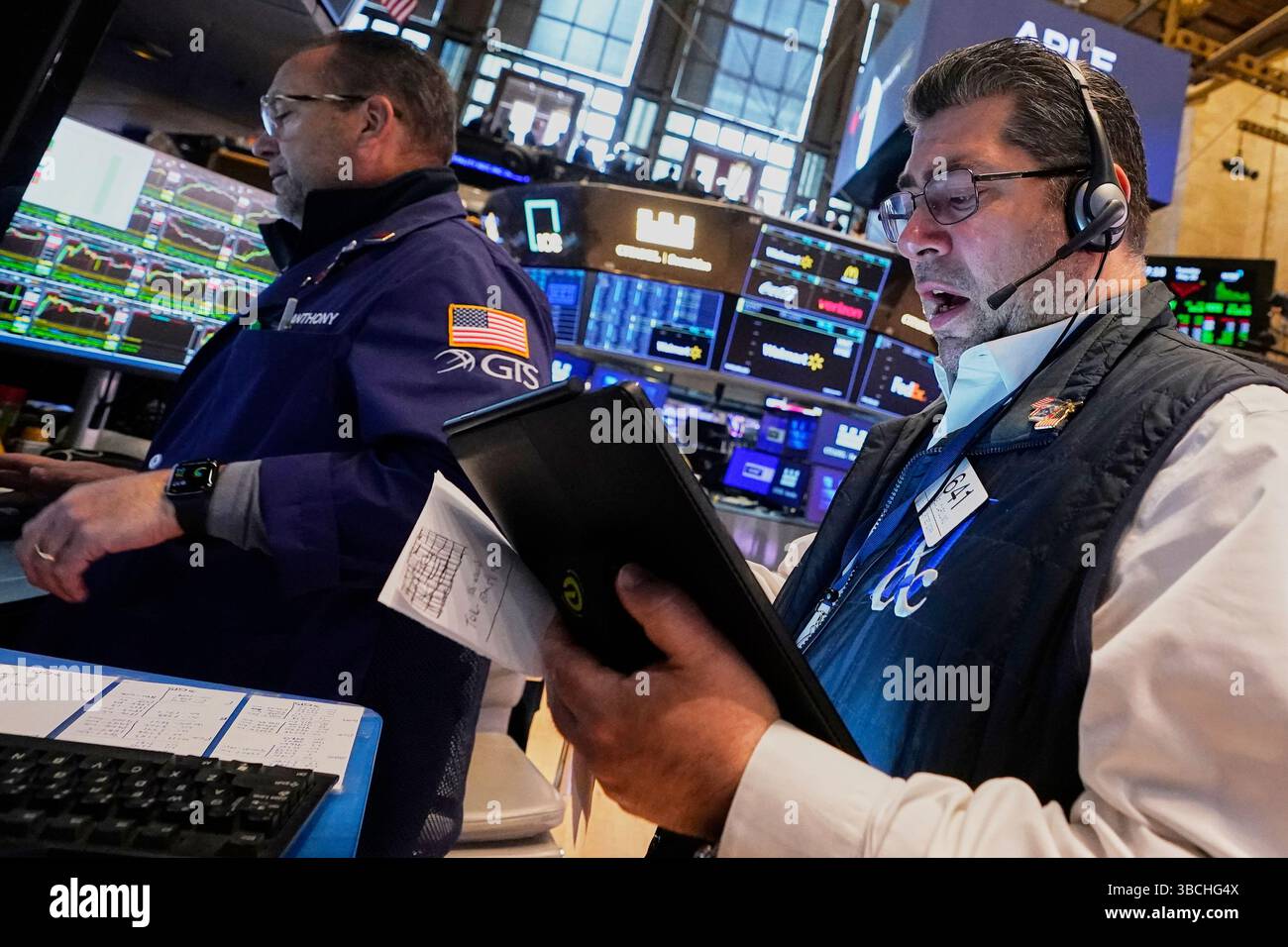 Specialist Anthony Matesic, left, and trader Michael Capolino work on ...