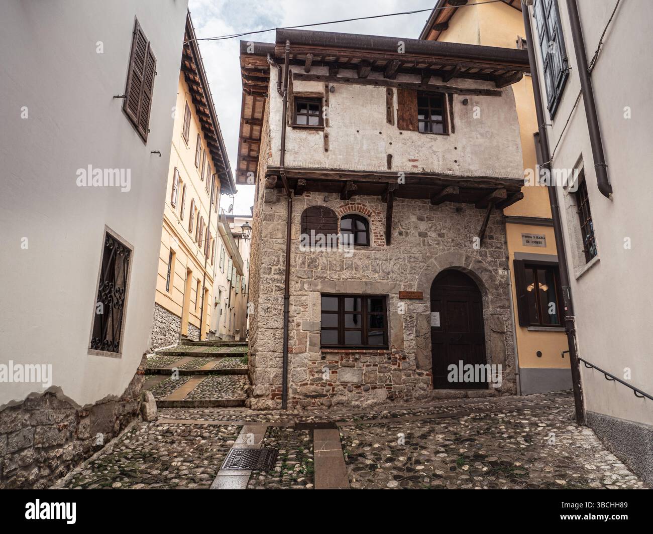 Historic stone house with wooden shutters and overhanging upper floor ...
