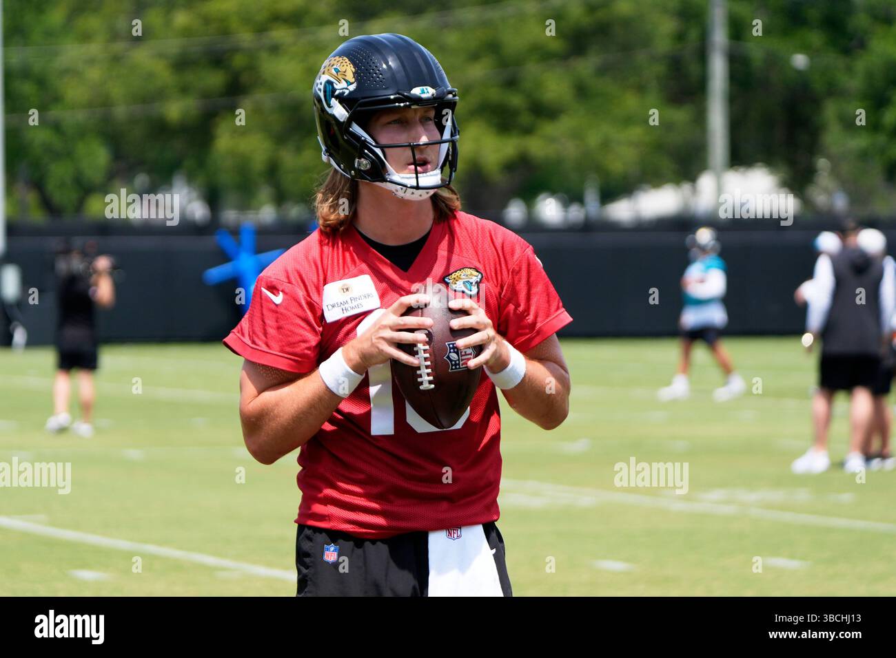 Jacksonville Jaguars quarterback Trevor Lawrence warms up during a team ...