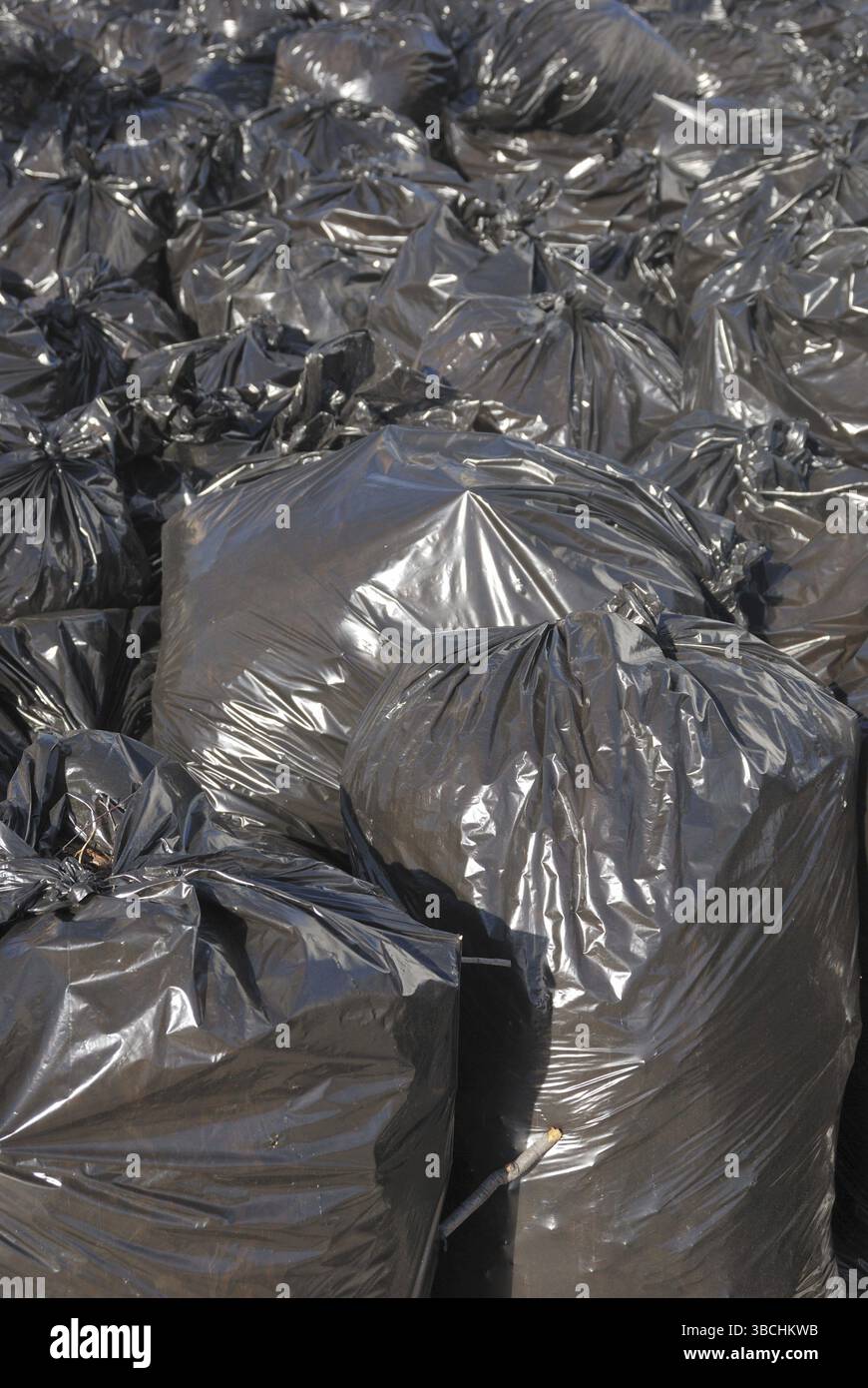 Pile of black garbage bags with tons of trash Stock Photo - Alamy