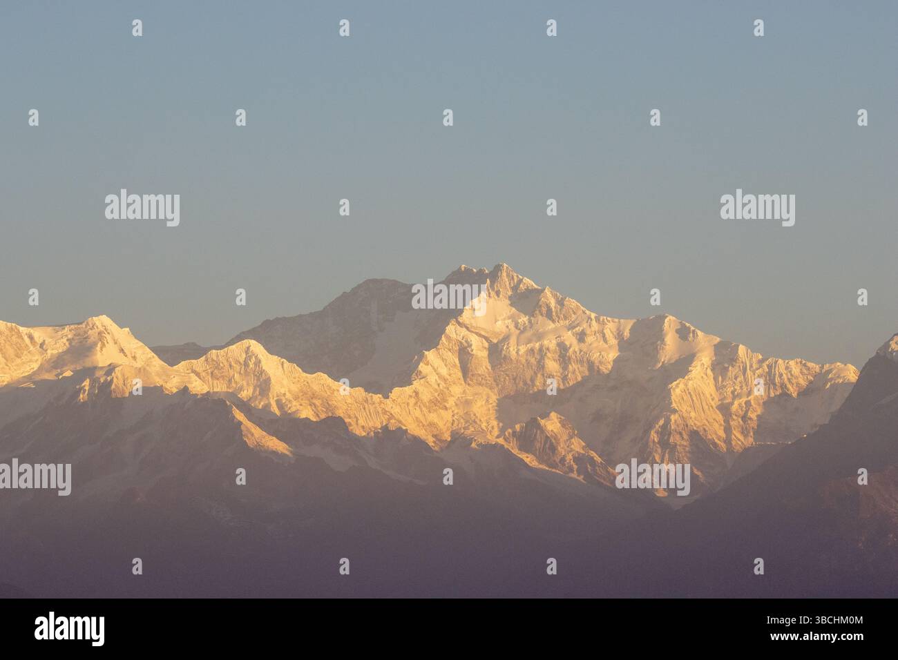 first light catches the peak of Kanchenjunga mountain in the Himalayas taken from Darjeeling ...