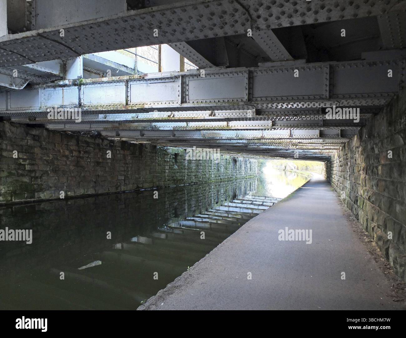 View under an old low steel girder bridge crossing the leeds to ...