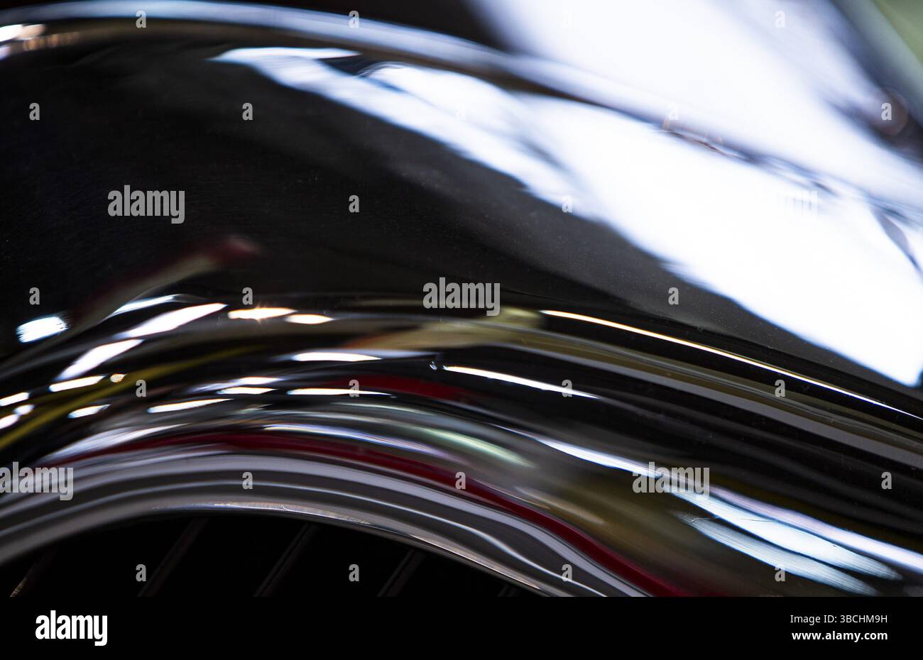 The photo shows a detailed view of a shiny mudguard of a classic car ...