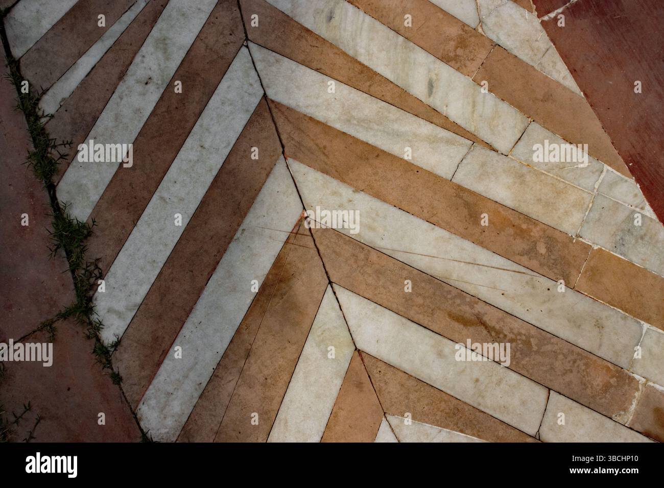 orange and white herring bone floor tiles in India Stock Photo - Alamy