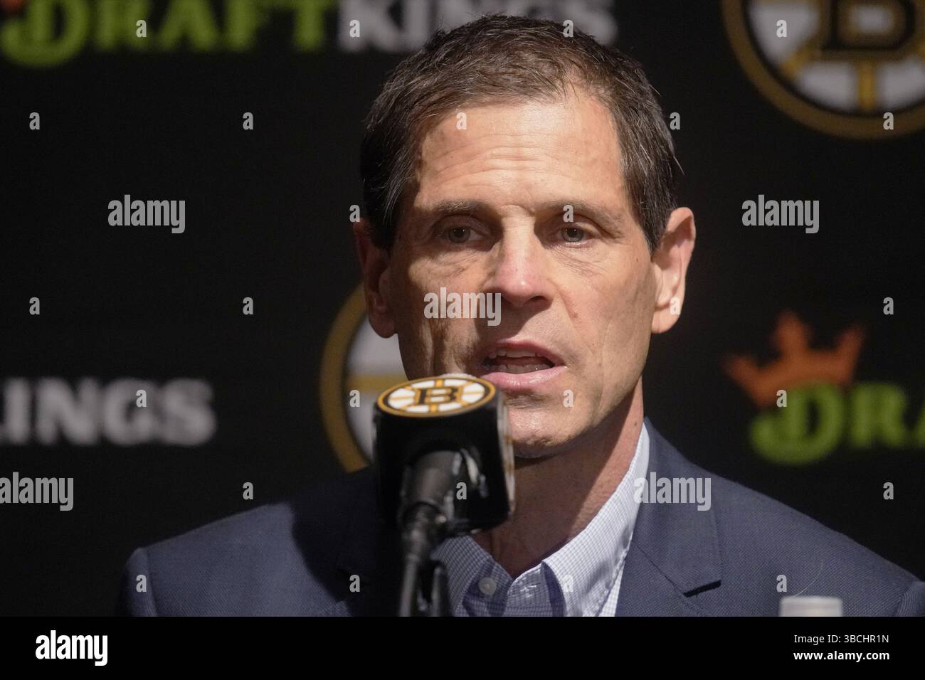FILE - Boston Bruins general manager Don Sweeney answers a reporter's ...