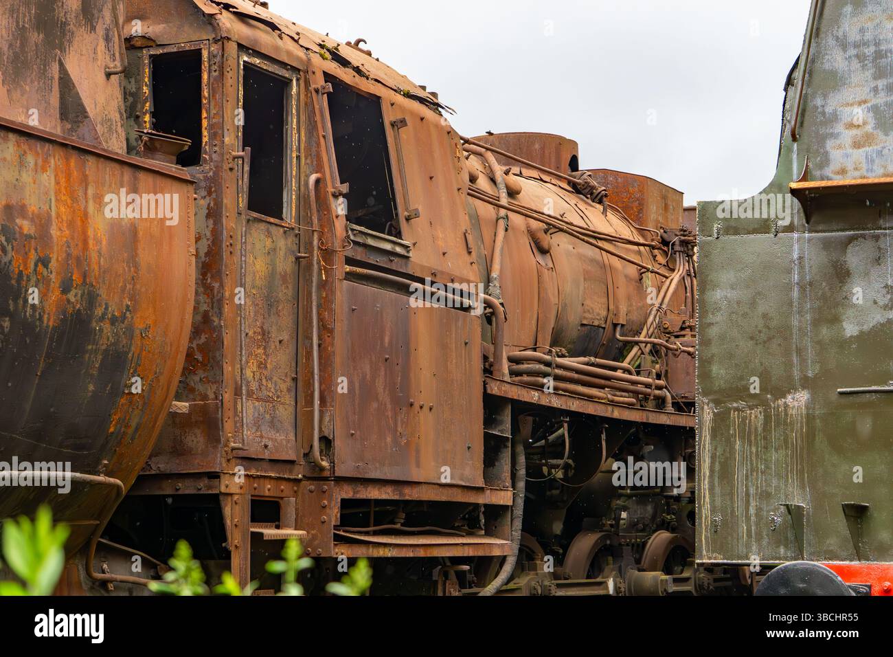 heavily rusted and decayed steam locomotive standing on a railway ...