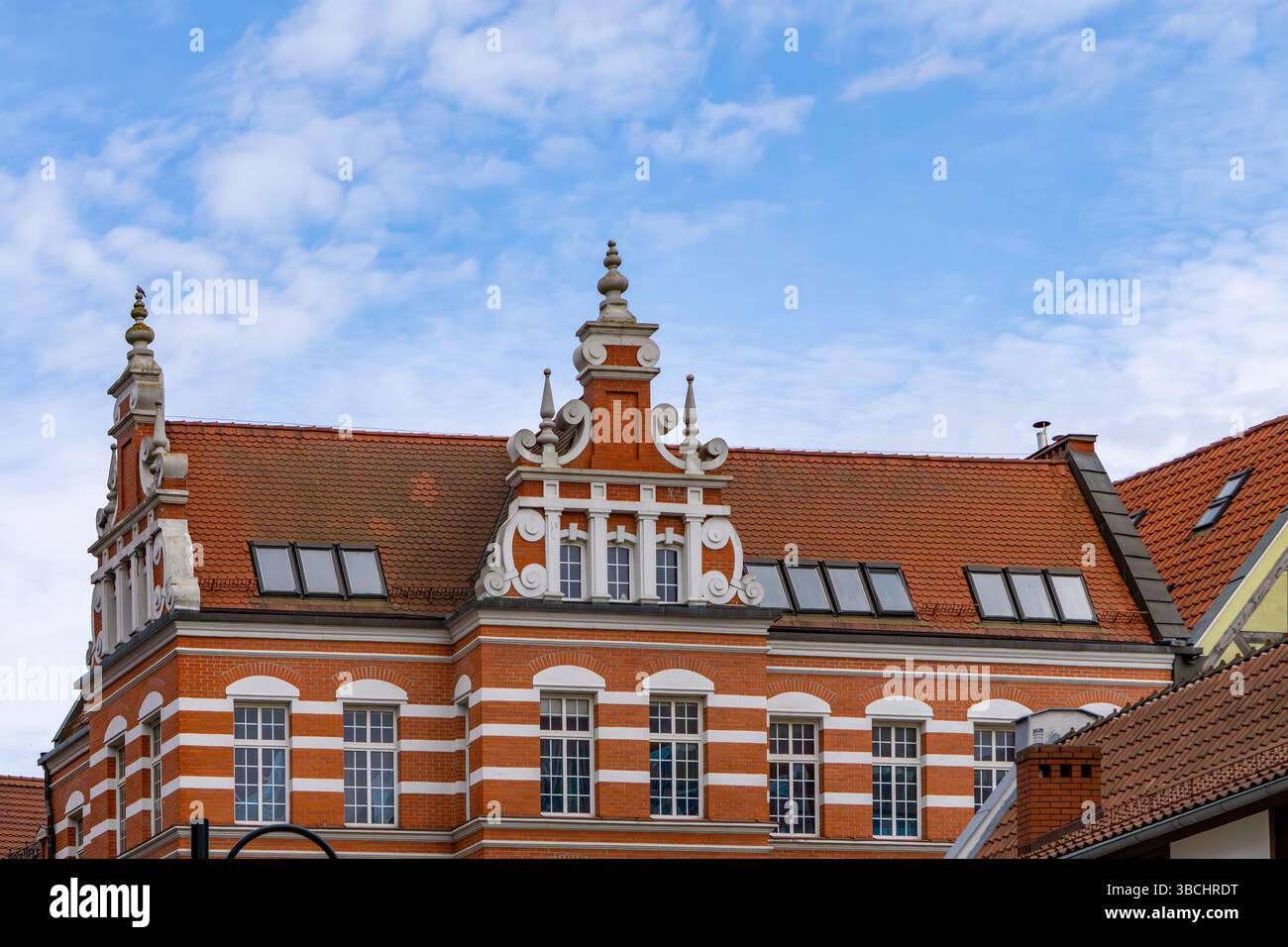 Historic red brick building with white architectural details and a ...