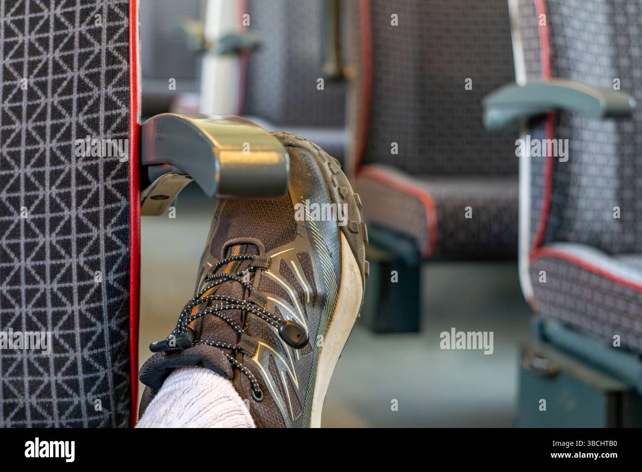 Close-up of the interior of a modern passenger train, showing a leg in ...