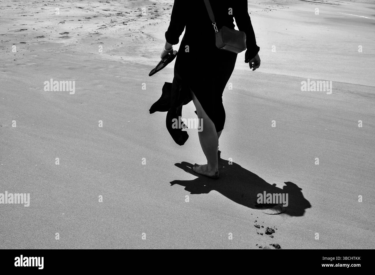 Woman walk barefoot on beach Black and White Stock Photos & Images - Alamy