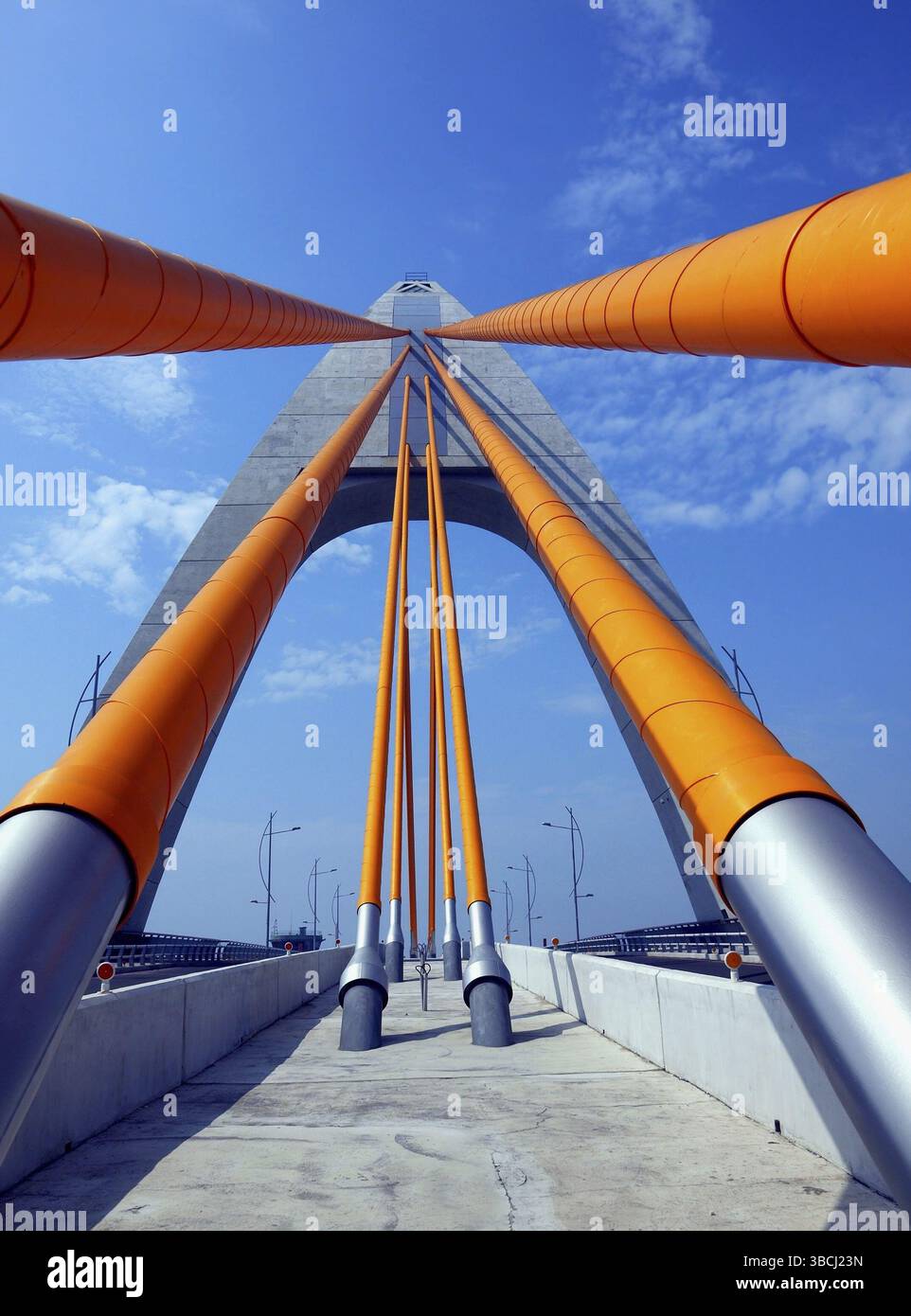 A modern single tower cable stayed bridge with massive steel cables ...