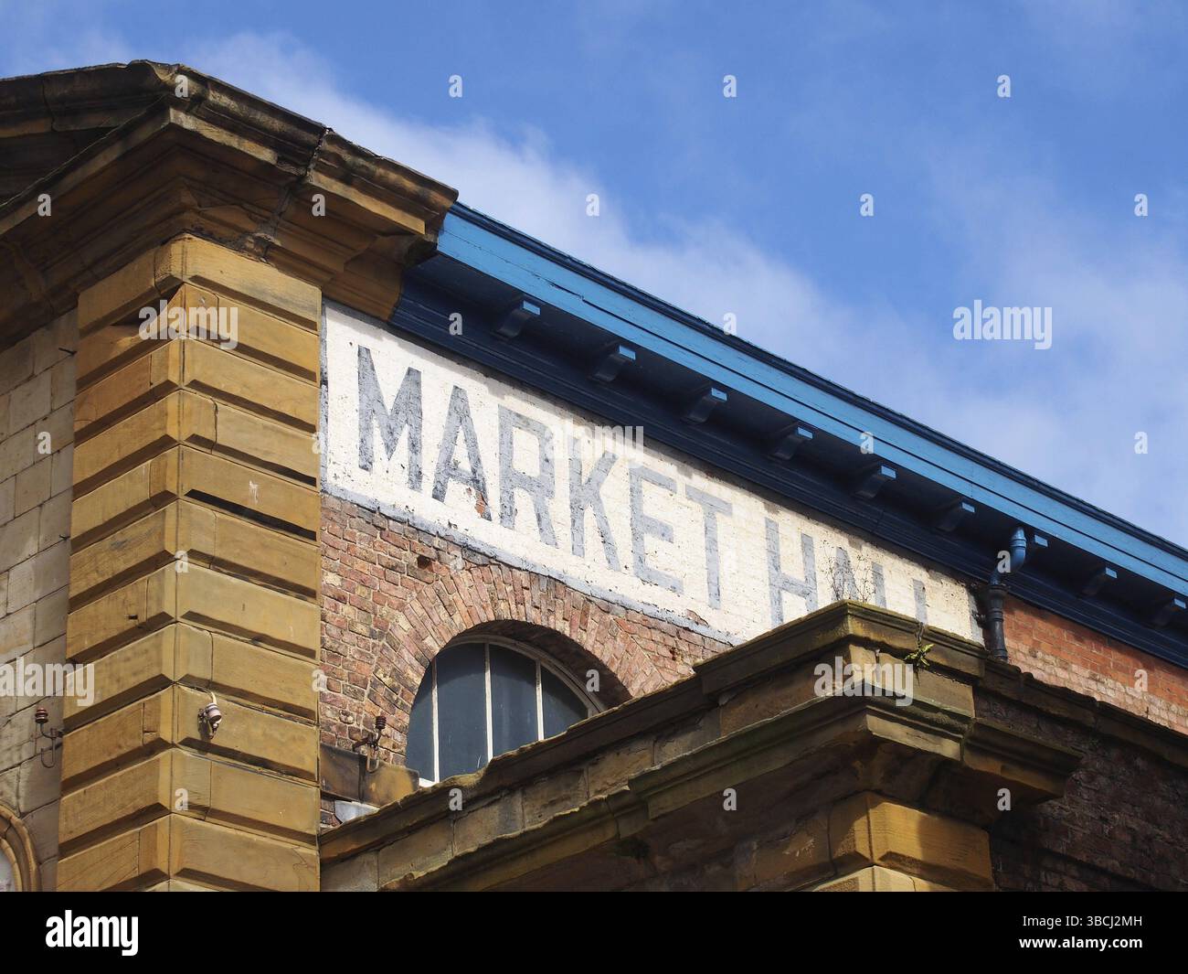 The historic public market building with signs and posters in ...