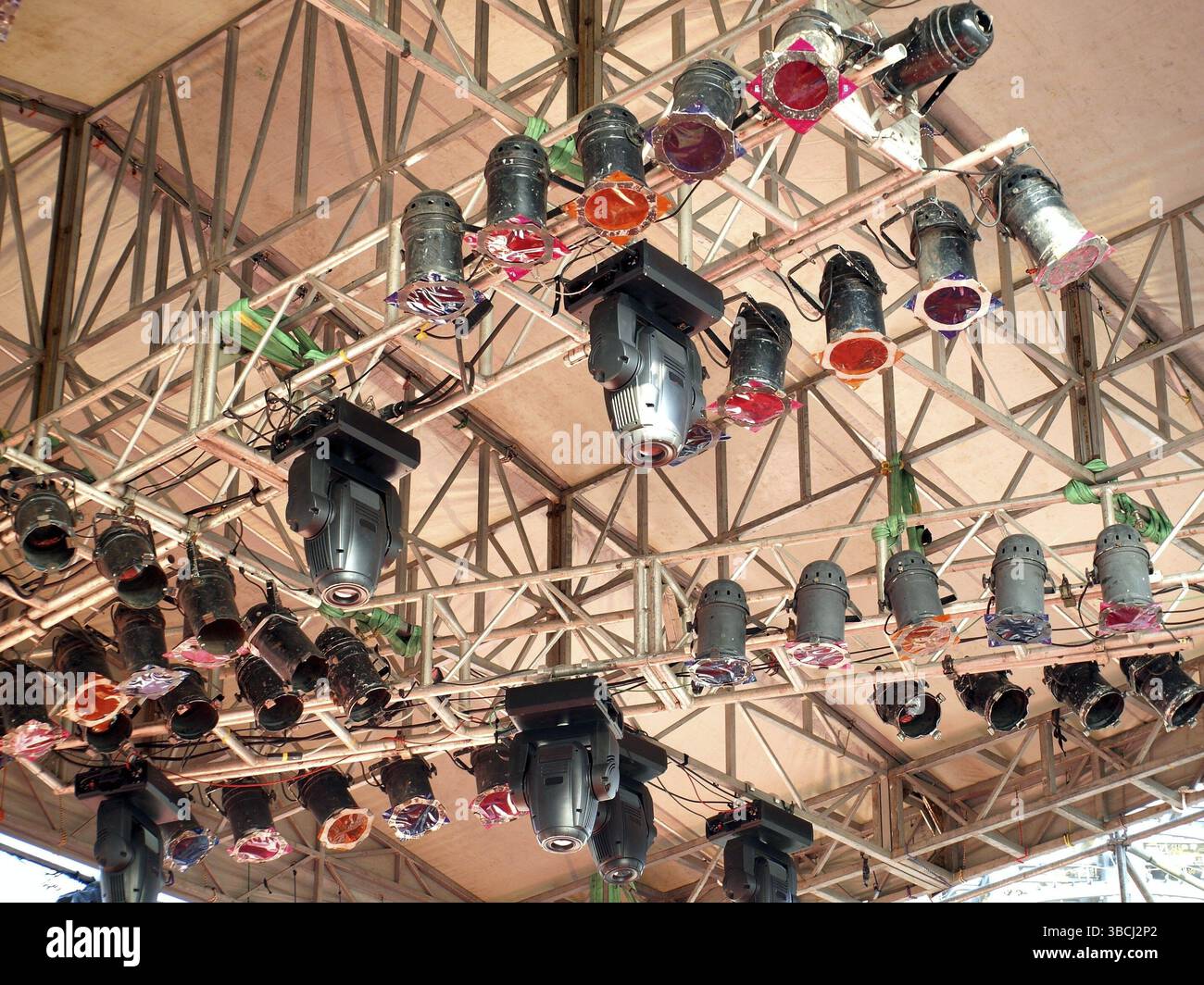 Multi-color spotlights and projectors form a complex stage lighting ...