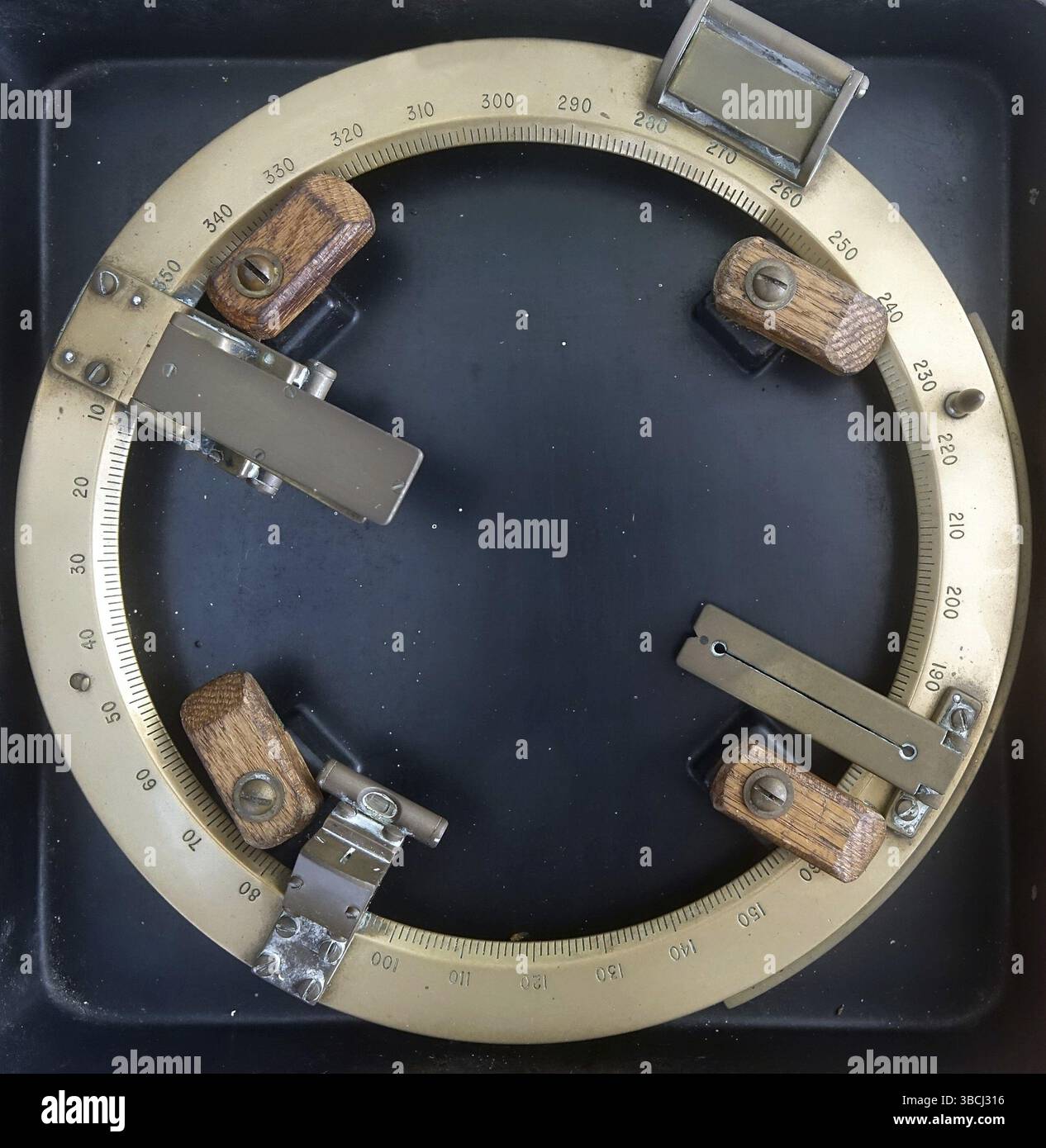 A vintage azimuth circle made from brass and used for ship navigation ...