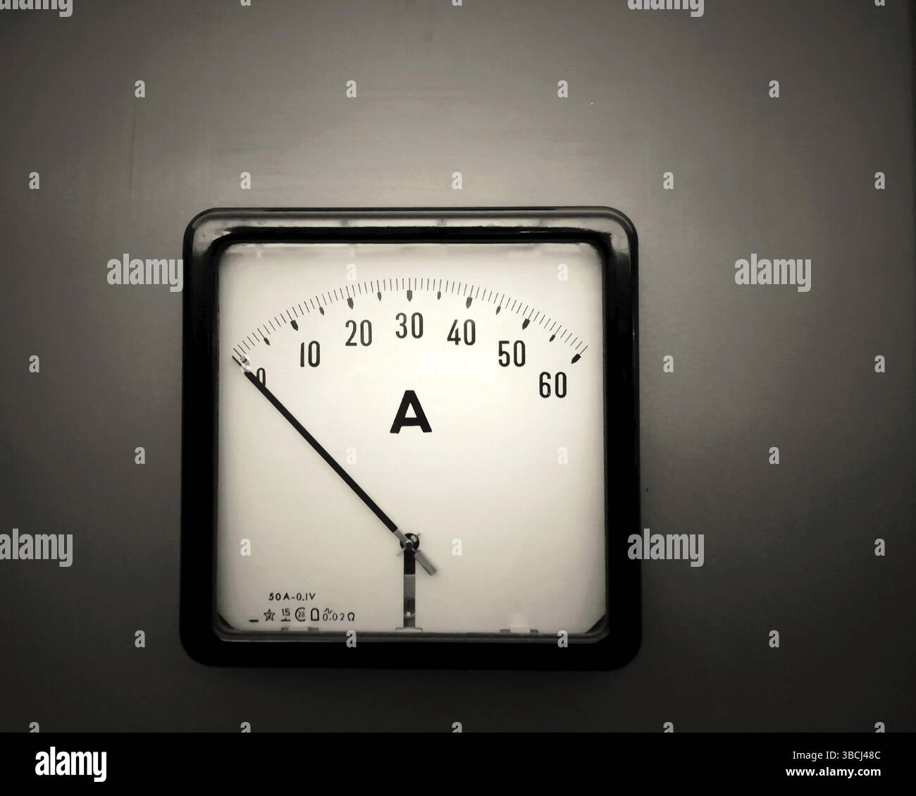 Monochrome square industrial ammeter with an analogue dial with numbers ...