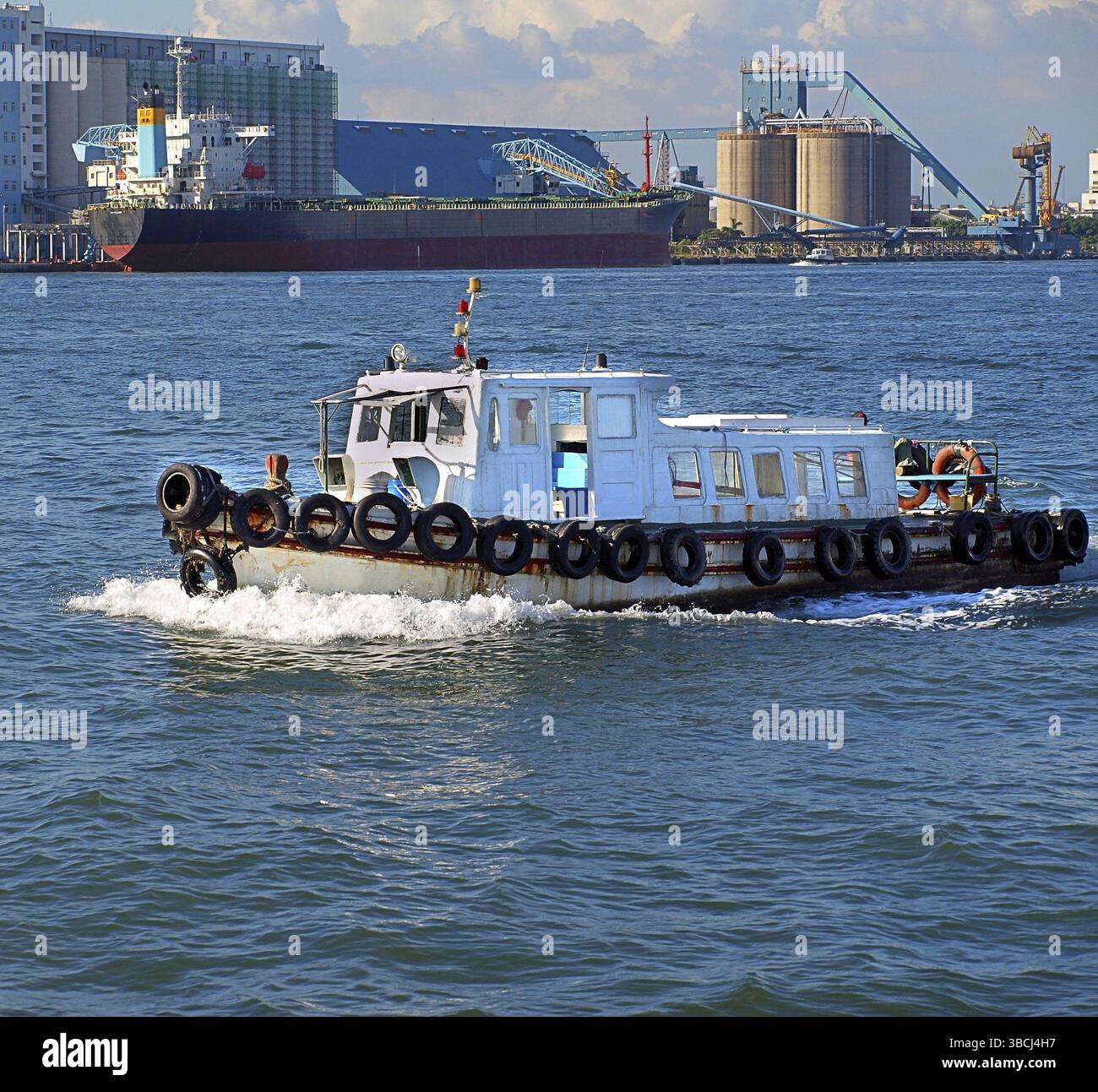 A small pilot boat makes its way through Kaohsiung port in Taiwan Stock ...