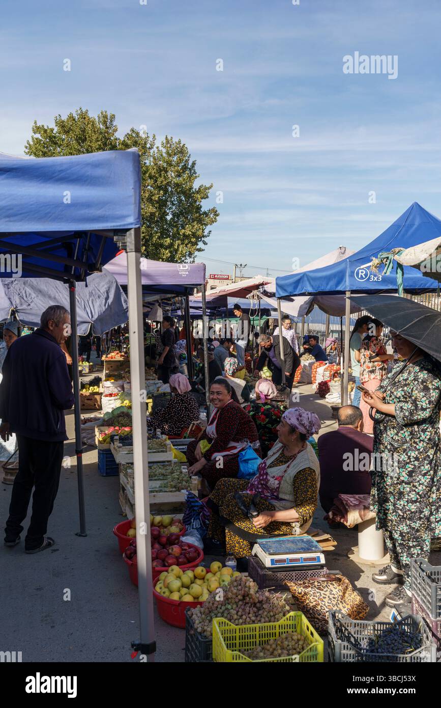 Market stalls bustle with people and fresh goods at Siab Bazaar, a ...