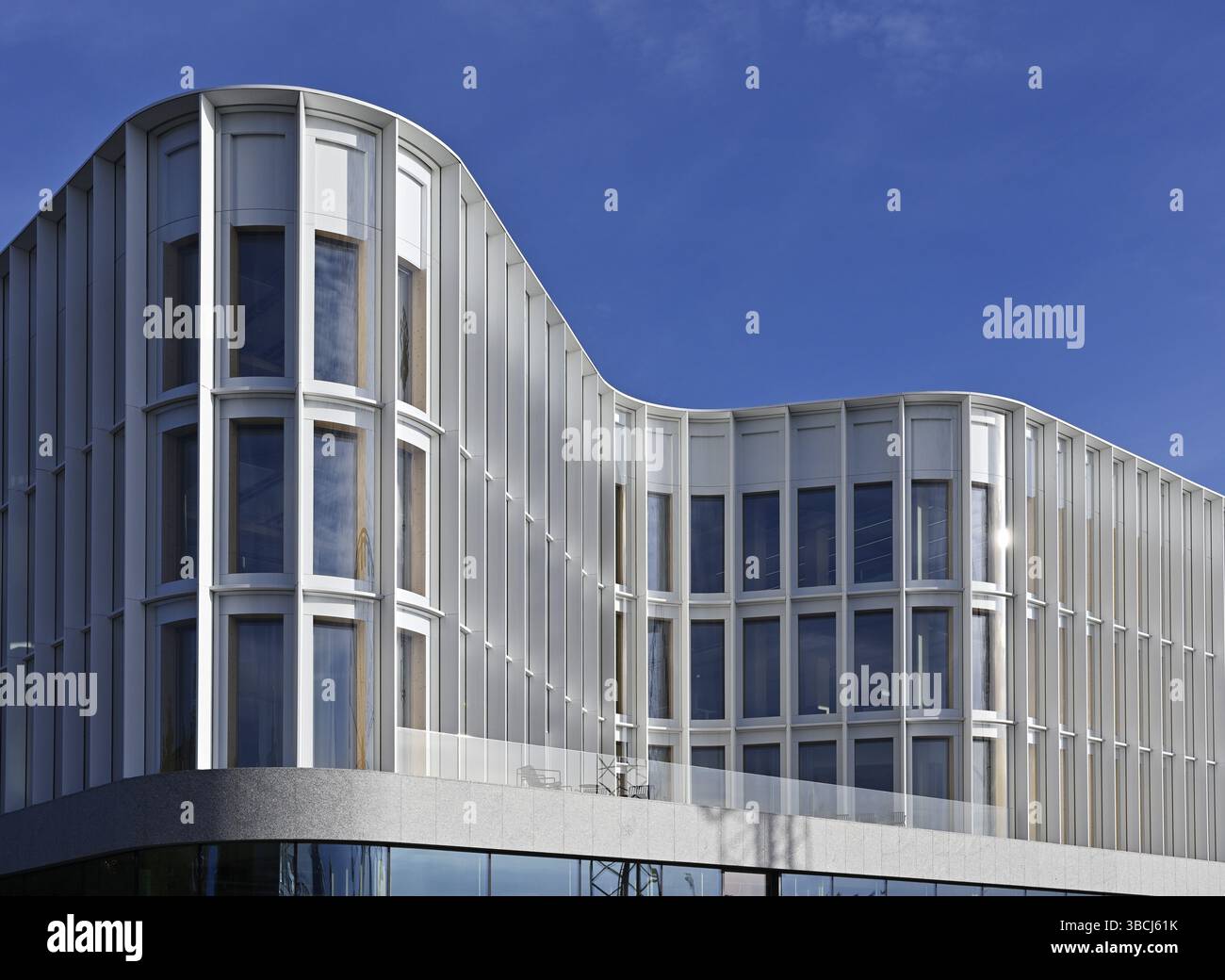 The image showcases a modern architectural building with a sleek and ...